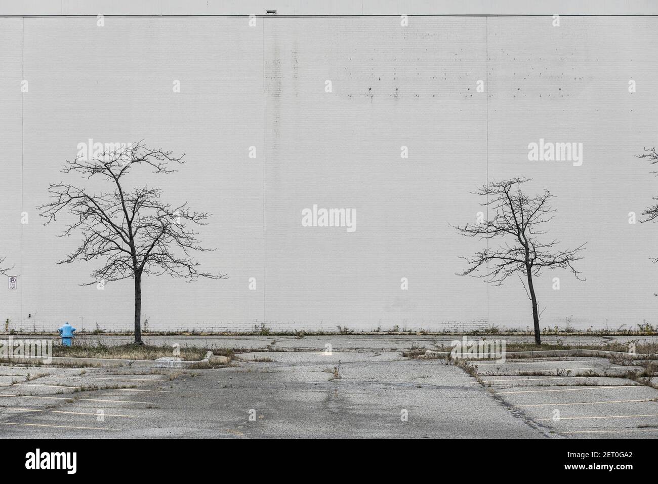 The faded outline of a logo sign outside of a closed Sears retail store ...