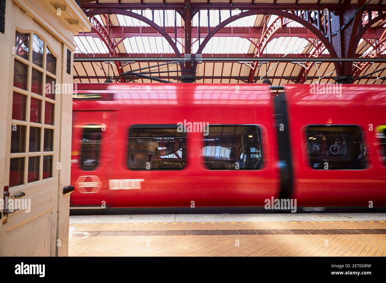 A train at a train-station going fast Stock Photo - Alamy