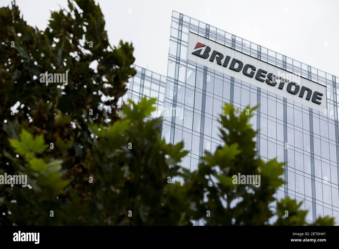 A logo sign outside of the headquarters of Bridgestone Americas in ...