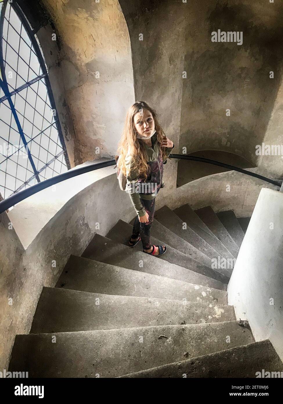 Girl standing on a spiral staircase Stock Photo - Alamy