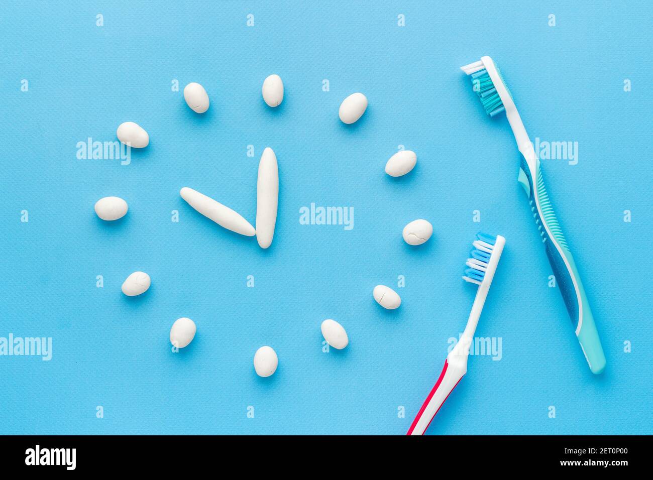 Clock made of toothpaste with toothbrushes. Oral care and dental ...