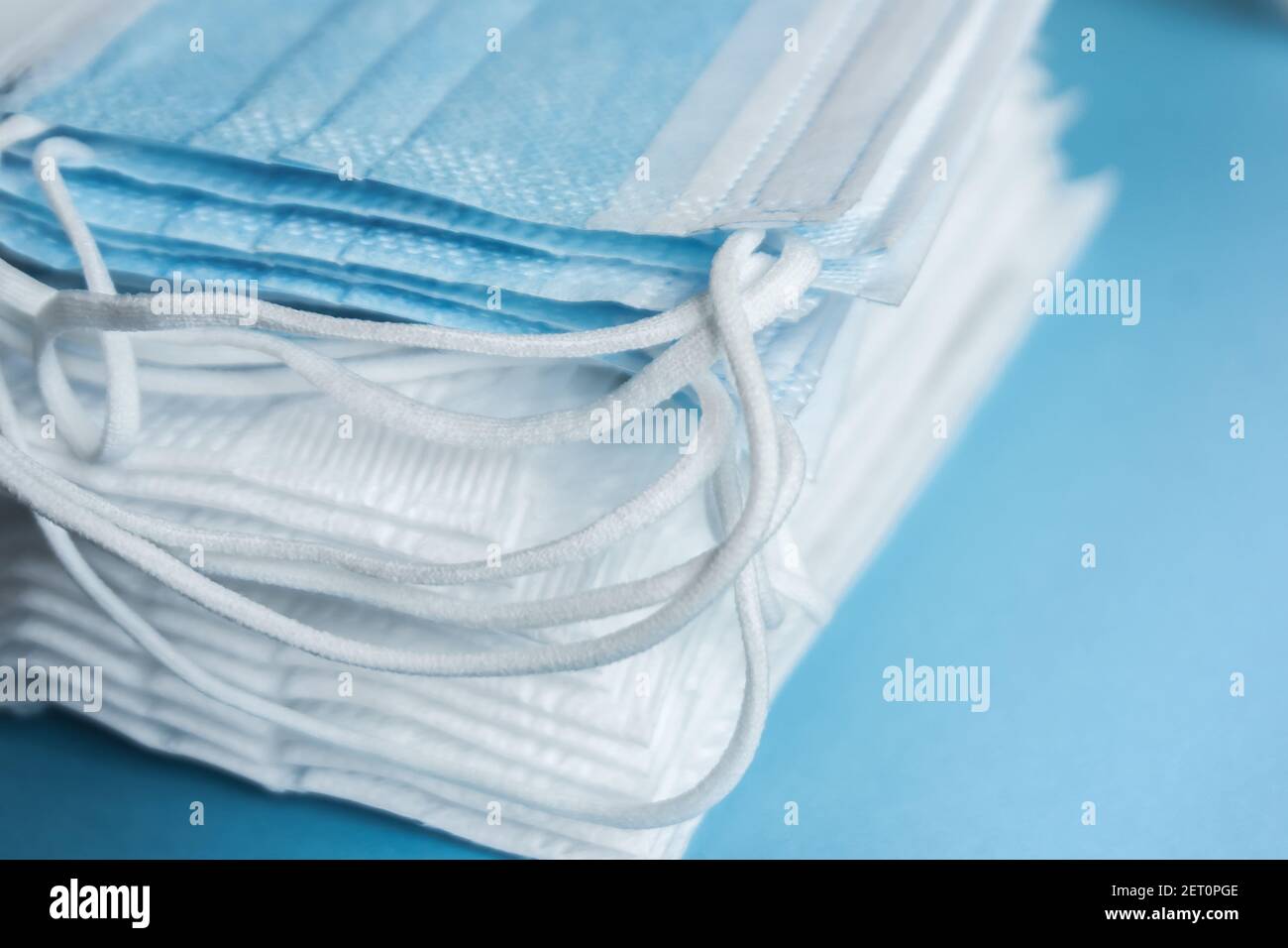 stack of surgical face masks,background white and blue Stock Photo - Alamy