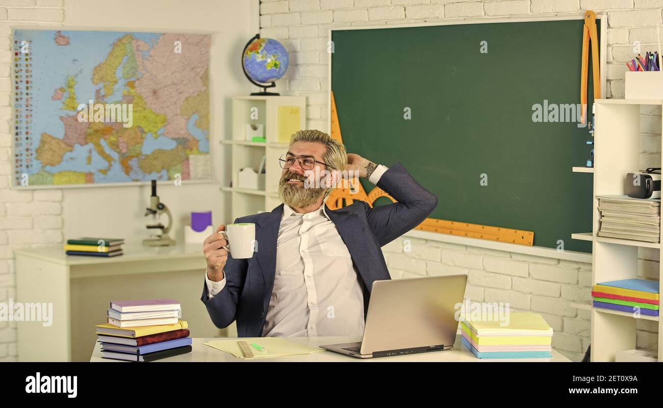 He needs fluid and rest. Happy man drink coffee in teachers room ...