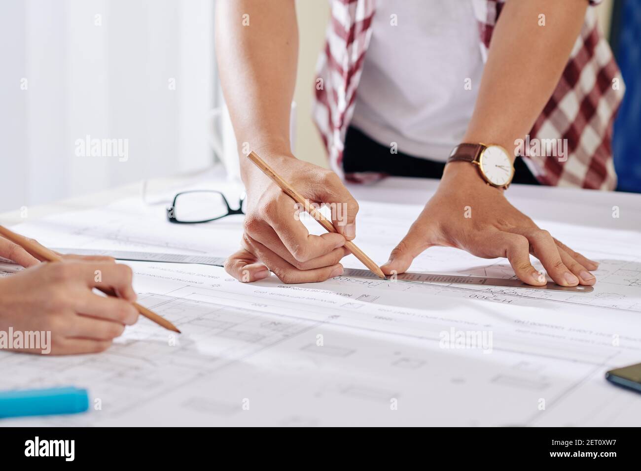 Architects working on construction plan Stock Photo - Alamy