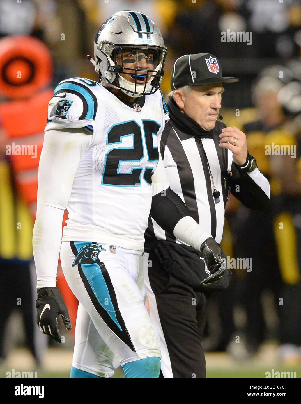 Carolina Panthers safety Eric Reid is led to the team's sideline by an ...
