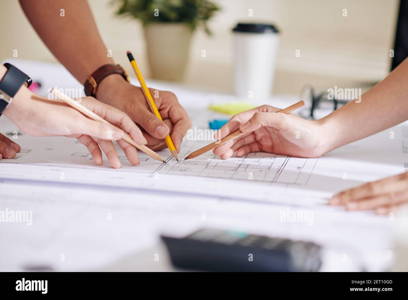 Architects pointing at blueprint Stock Photo - Alamy