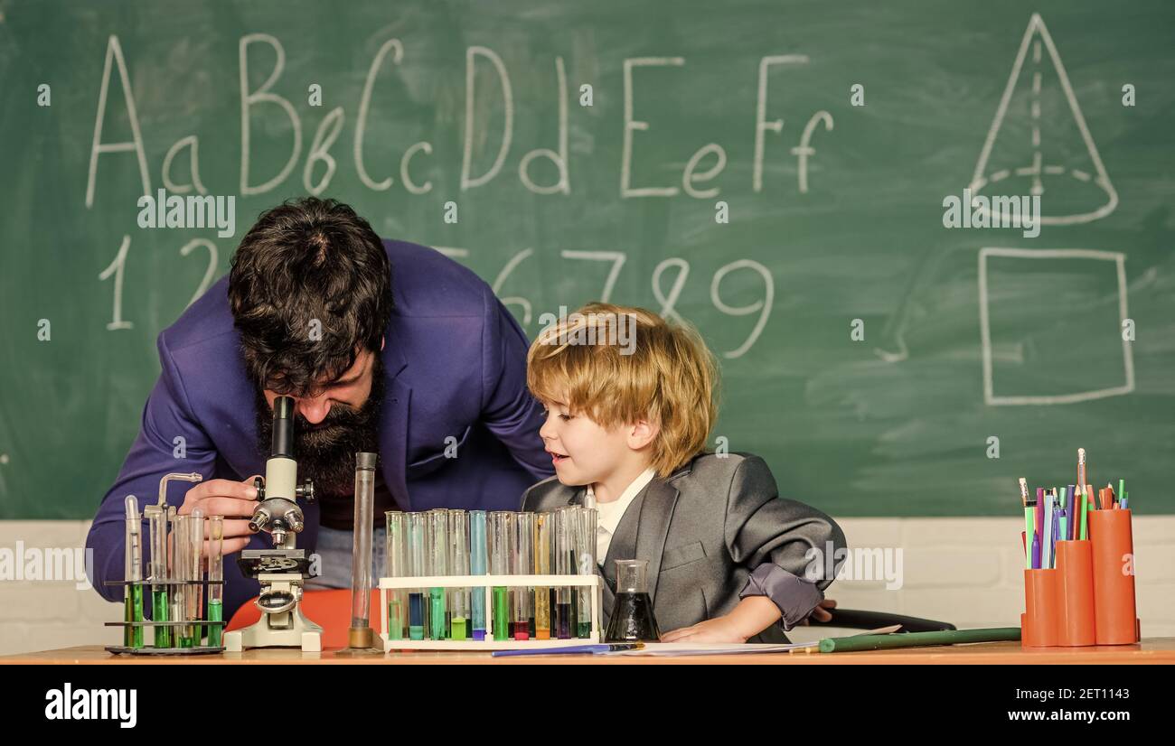 teacher man with little boy. school kid scientist studying science ...