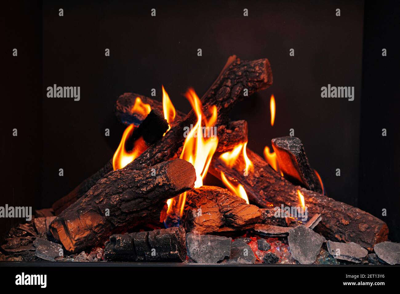 Wood logs burning in fireplace close up Stock Photo - Alamy