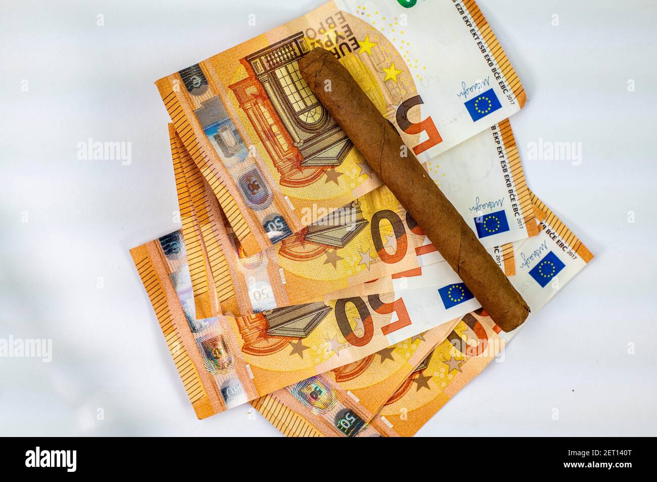 50 euro bills with cigar on white background Stock Photo - Alamy