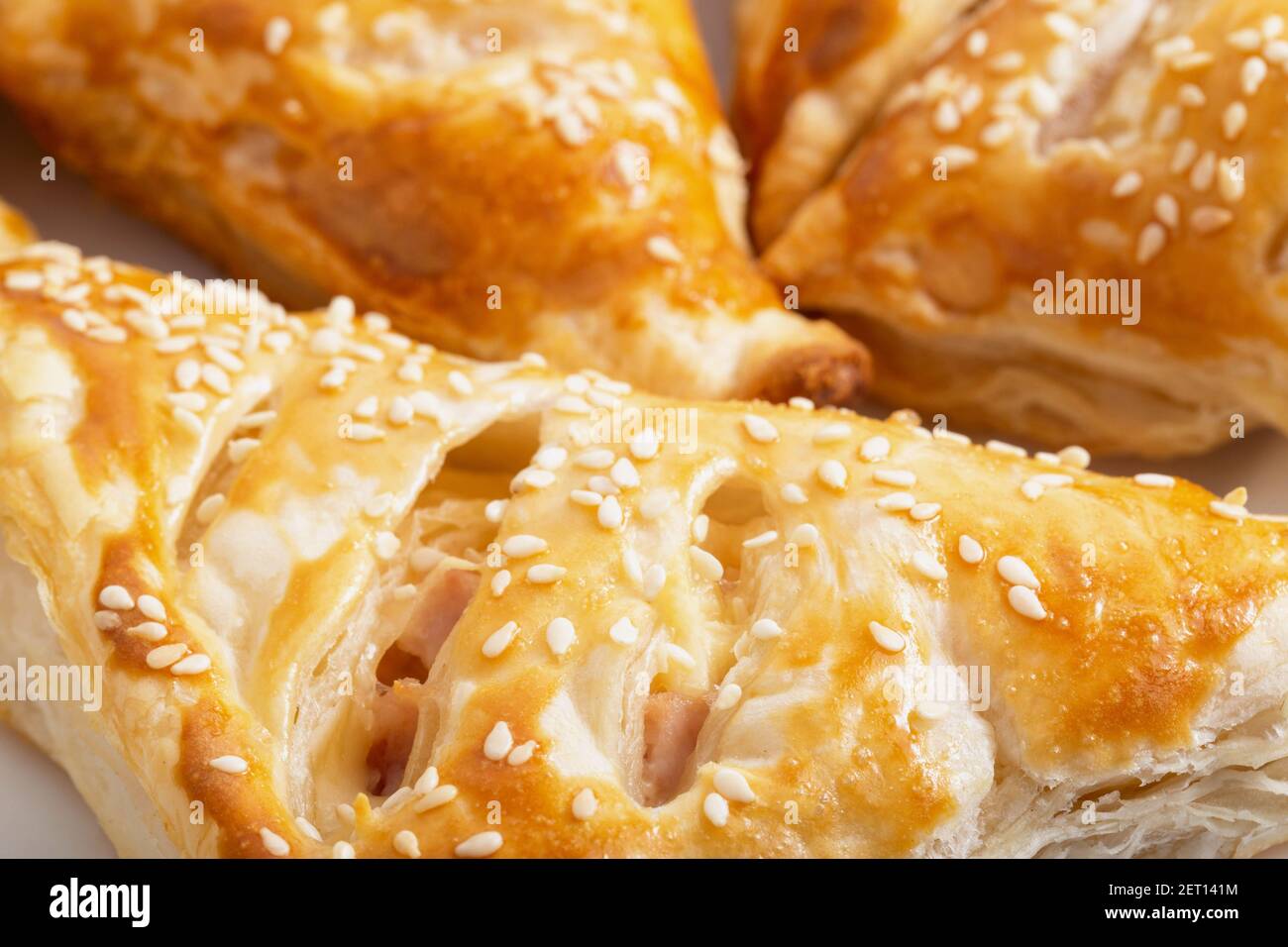 Delicious crunchy puffs with sesame seeds, ham and cheese. Delicious ...