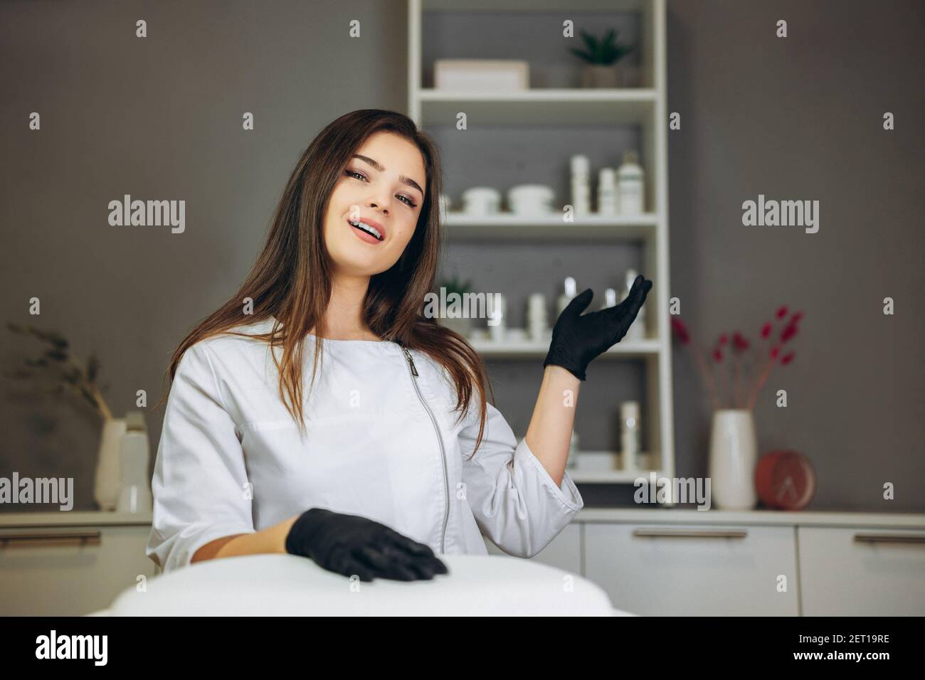 Consultation in cosmetology clinic. Female beauty doctor in white coat ...