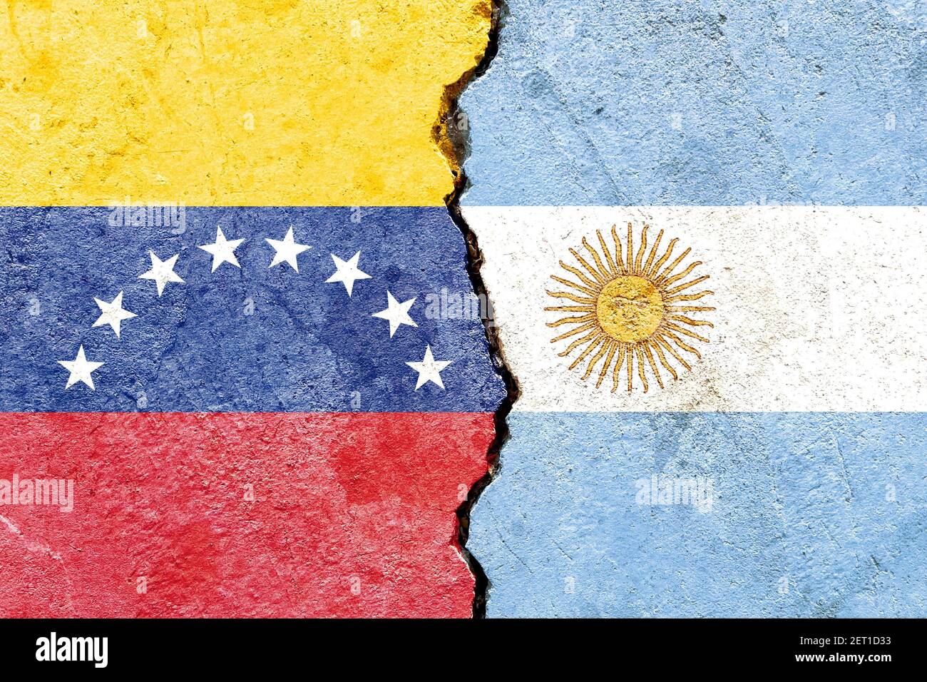 A top view of a cracked stone painted with the flags of Venezuela and ...