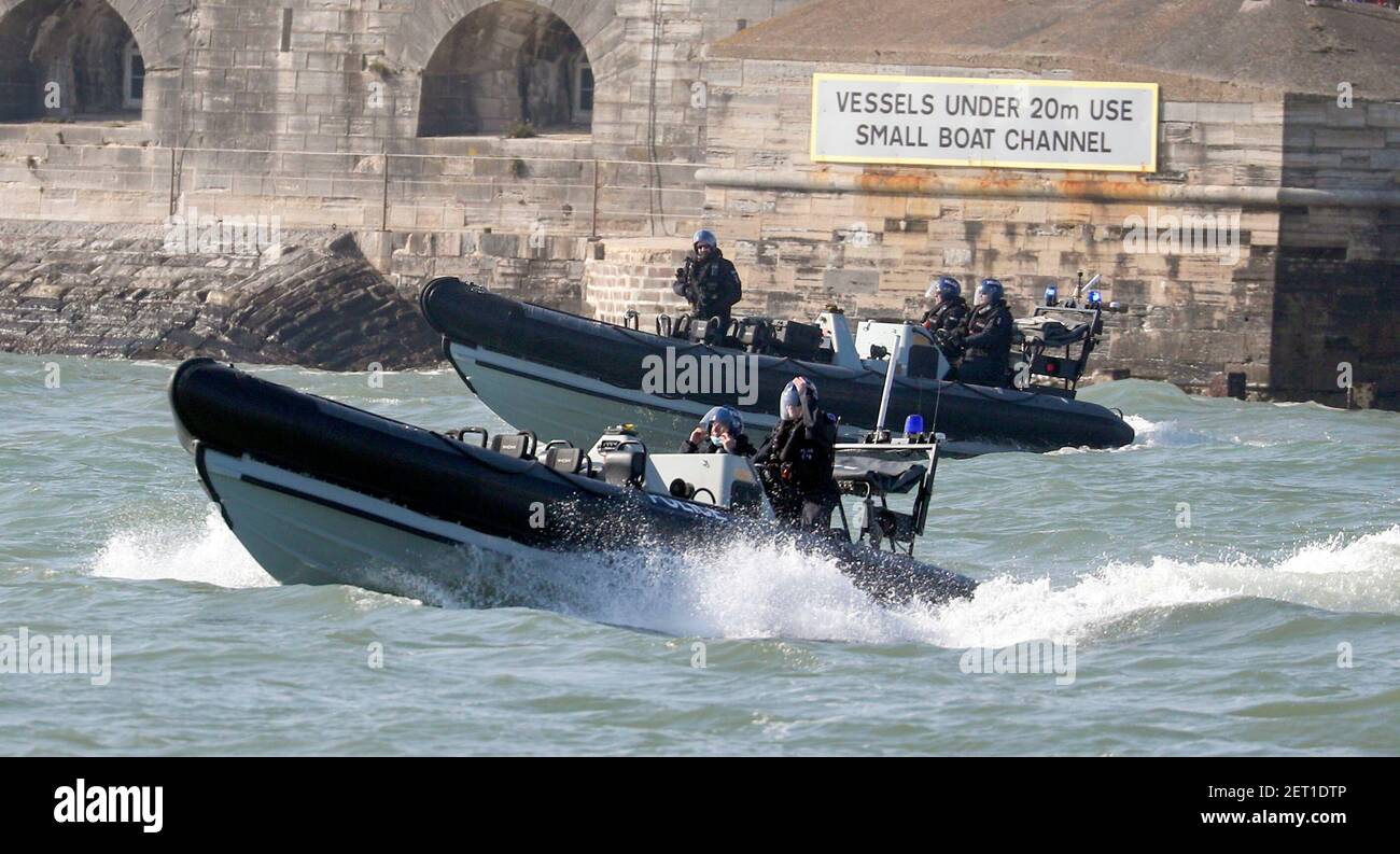 Police ribs escort the Royal Navy aircraft carrier HMS Queen Elizabeth ...