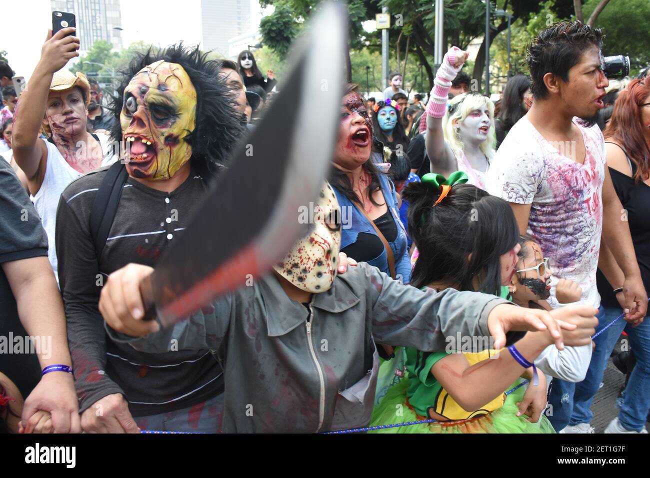 People disguised as monsters take part in the 20th annual Zombie Walk ...