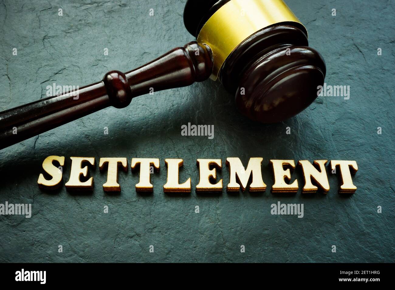 Settlement word from wooden letters and gavel Stock Photo - Alamy