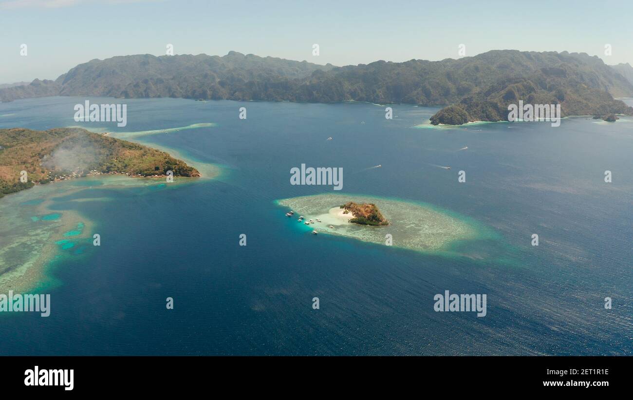 aerial view tropical island with sand white beach, clear and blue water ...