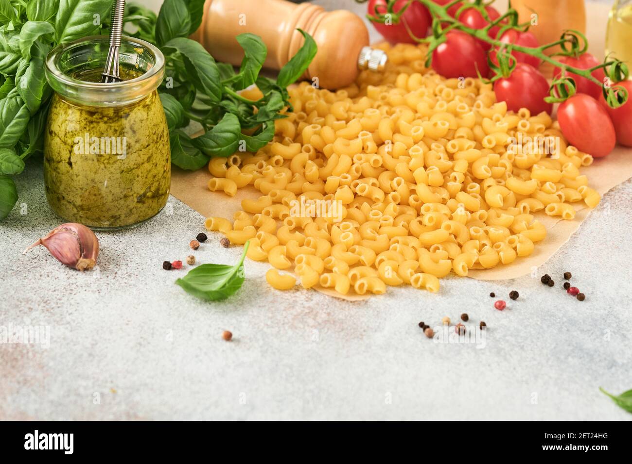 Chifferi rigati classic raw pasta in brown paper on light wooden table ...