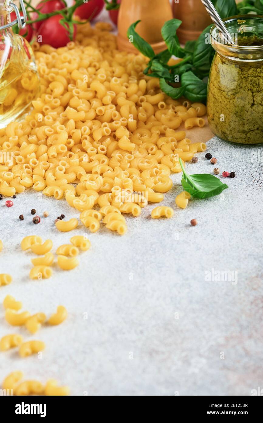 Chifferi rigati classic raw pasta in brown paper on light wooden table ...