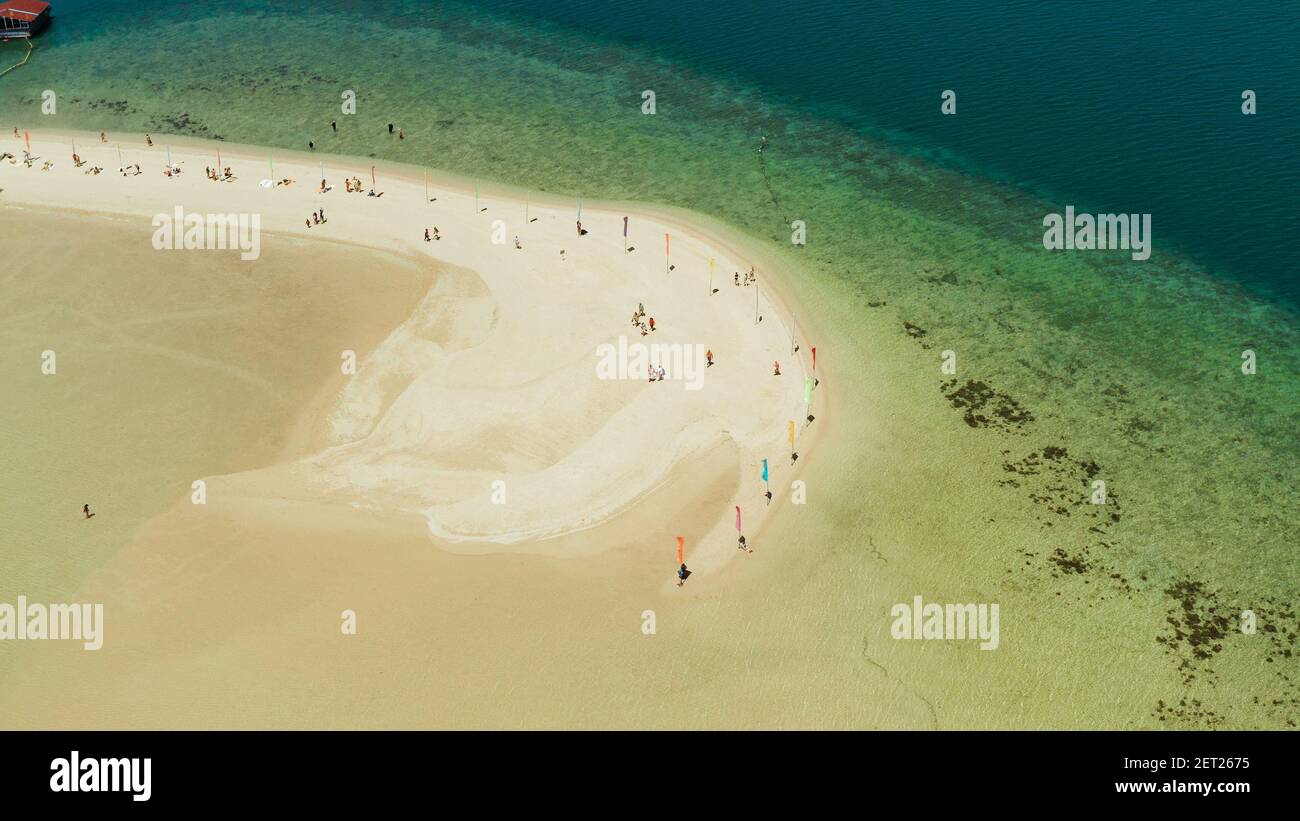 Luli island and sandy beach with tourists, sand bar surrounded by coral ...