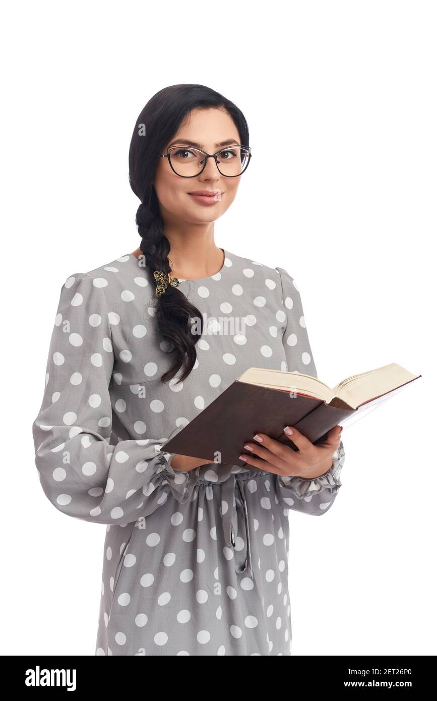 Attractive young lady with long dark pigtail standing over white ...