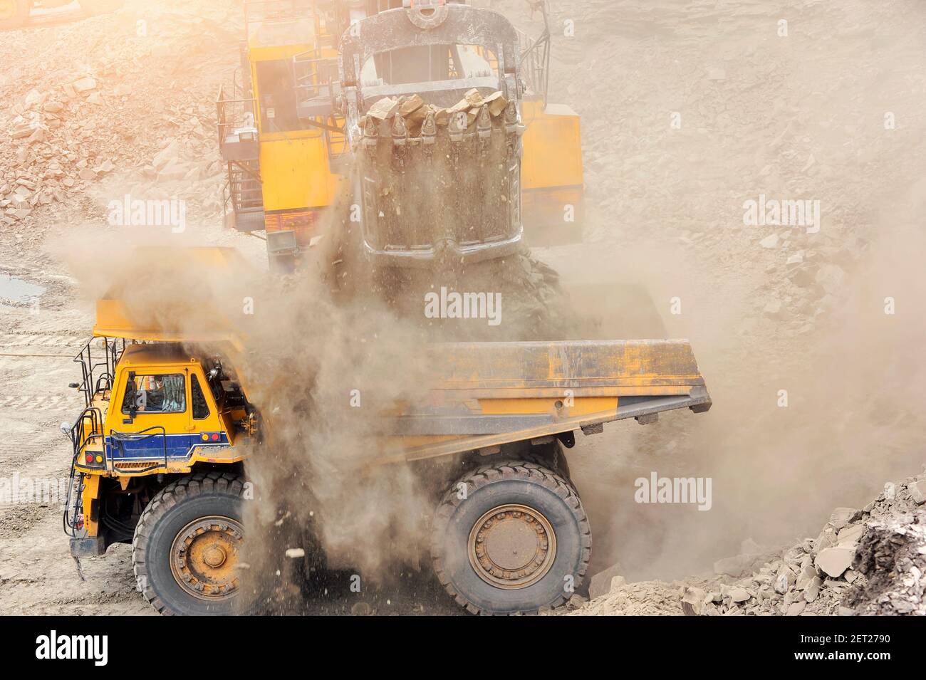 Mining Truck loading iron ore into a dump truck at an opencast mine ...