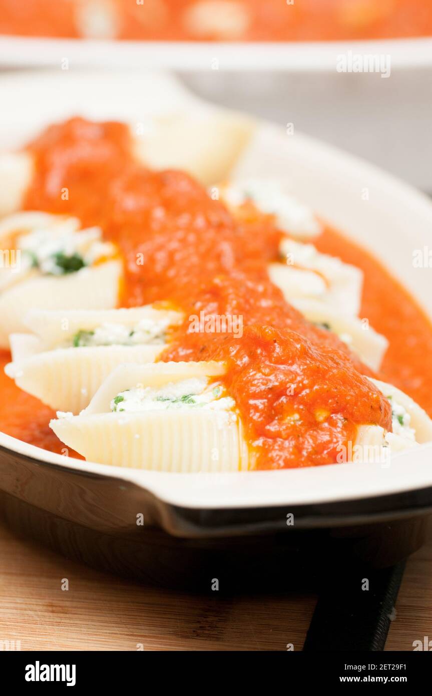 uncooked hand stuffed conchiglie pasta with goat cheese and spinach and ...