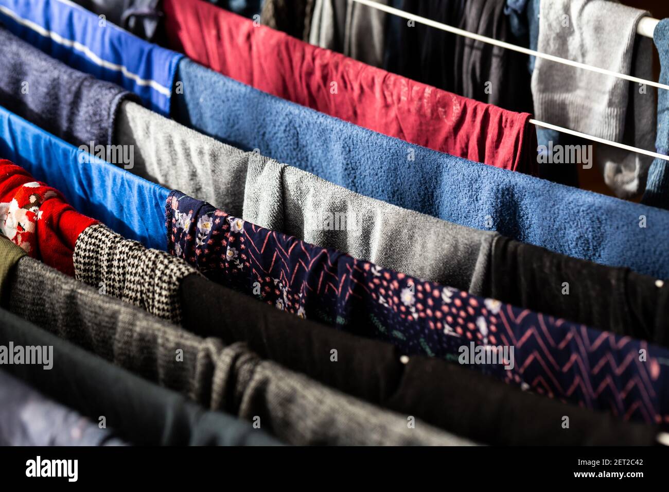Laundry drying in a room bar dryer. Natural light shining through the ...
