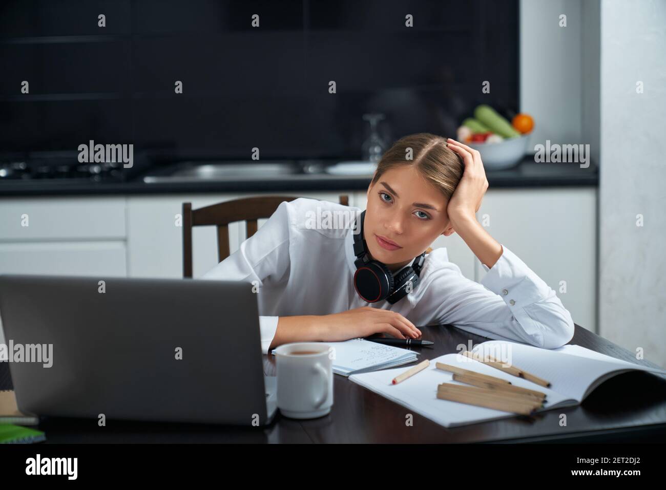Young woman feeling exhausted after remote work on modern laptop ...