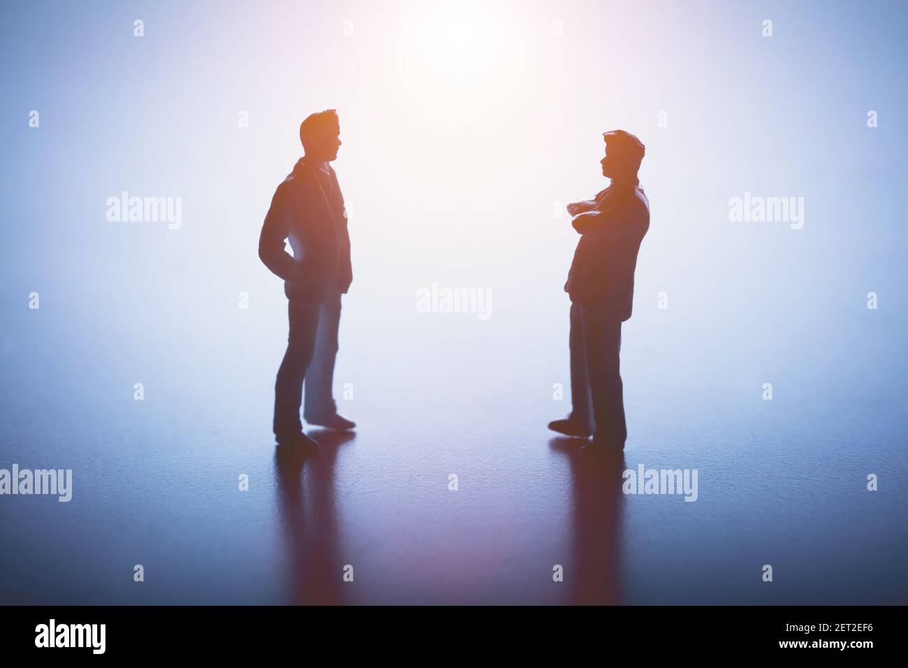 Two man standing face to face on white background. Business ...