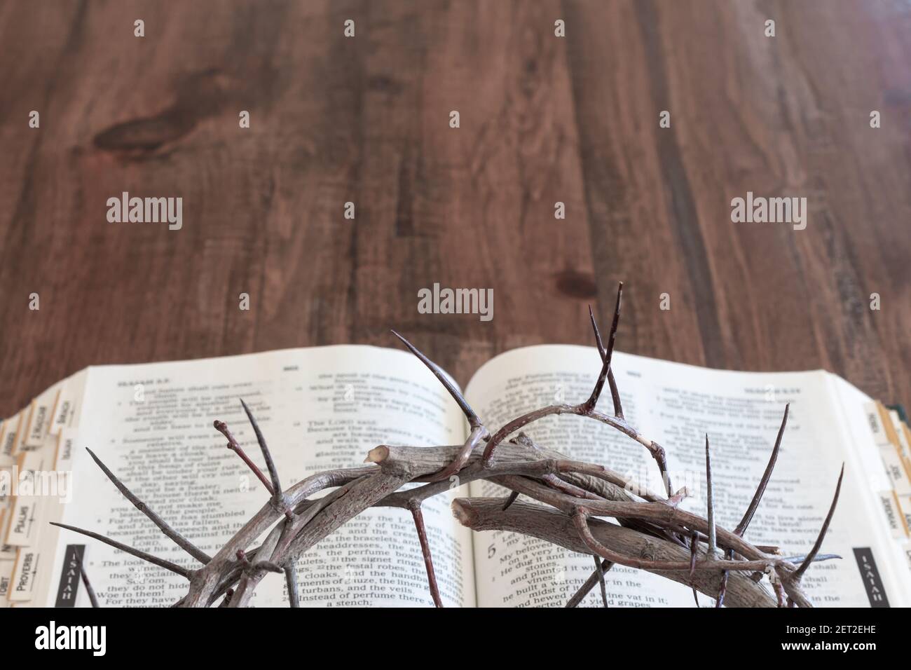 open bible on dark wood table centre bottom with partial crown of ...