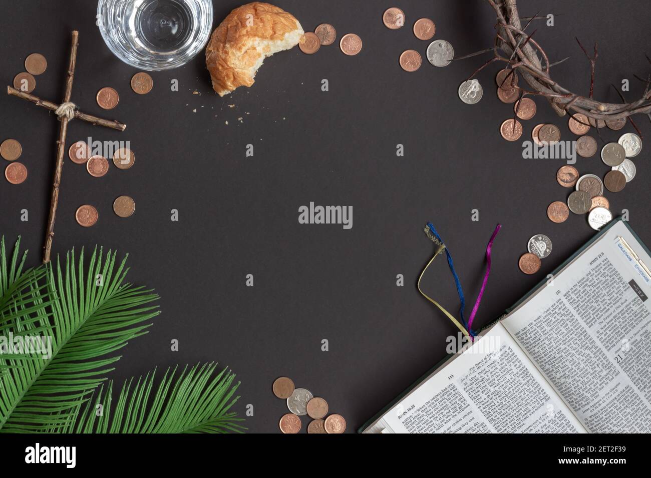 Lent border or frame on black background with cross, palm leaves, glass ...