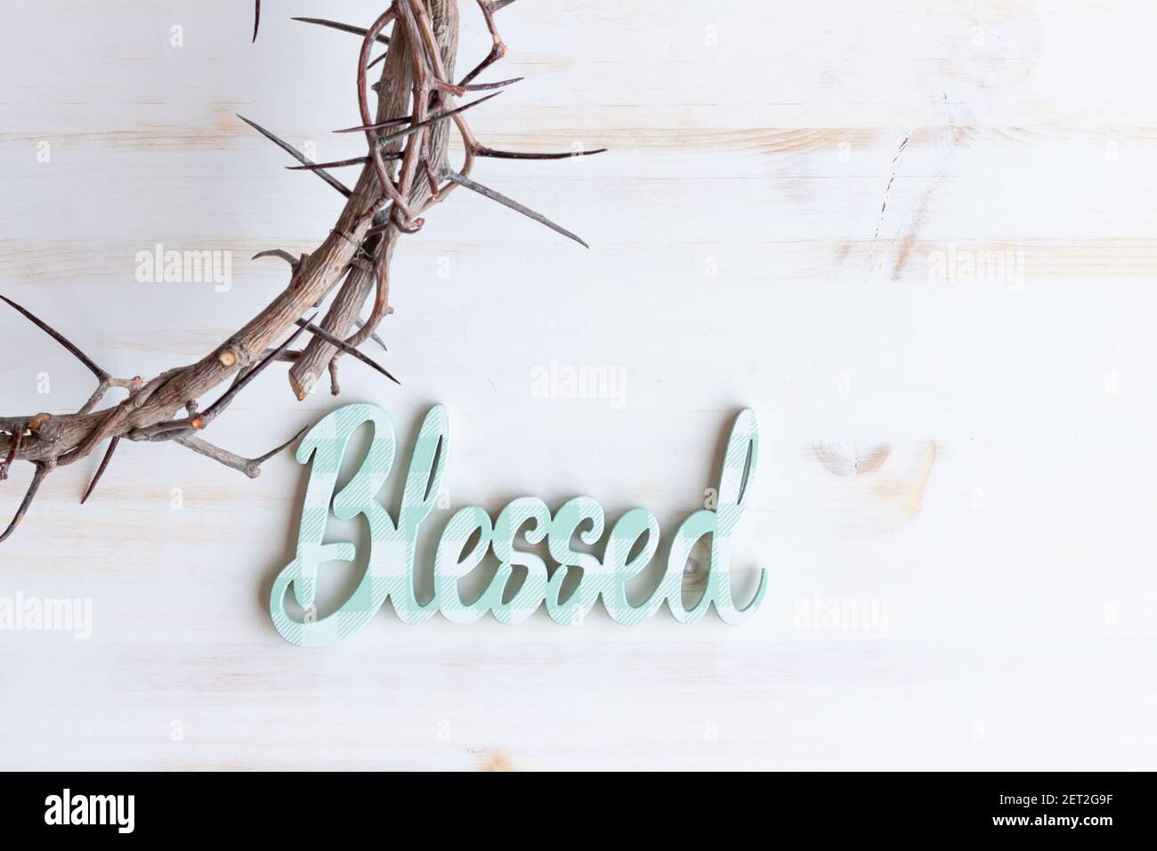 Crown of thorns with word blessed on a white background with copy space ...