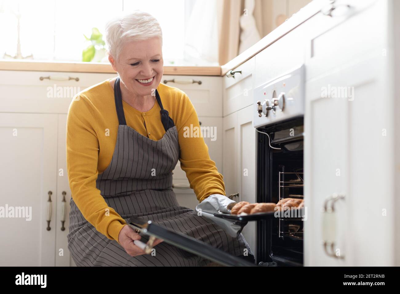Woman opening oven hi-res stock photography and images - Alamy