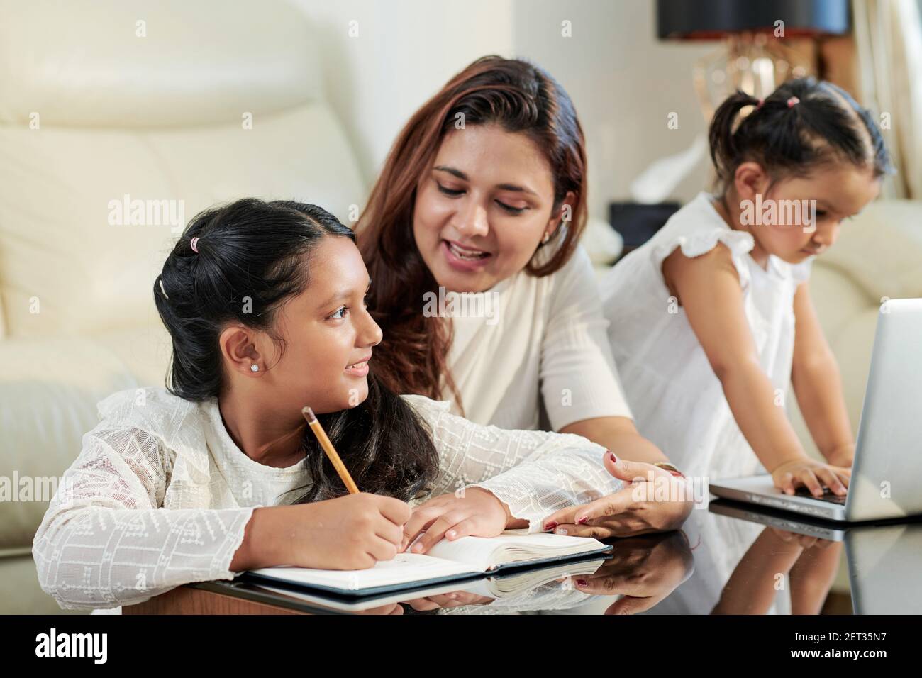 Mother helping with homework Stock Photo - Alamy