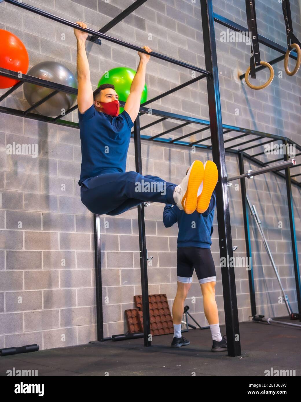A view of Two athletes performing strength exercises in the gym during ...