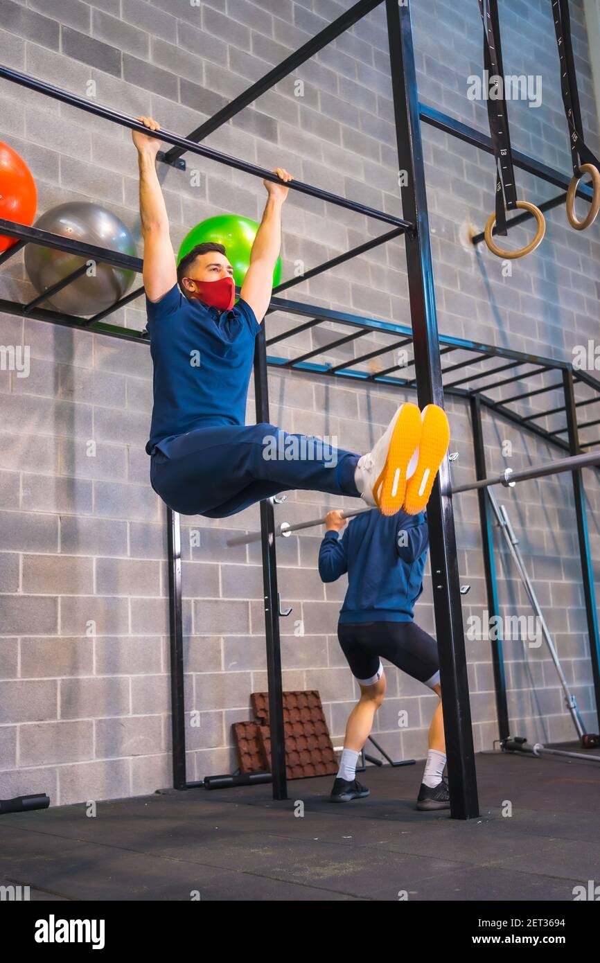A view of Two athletes performing strength exercises in the gym during ...