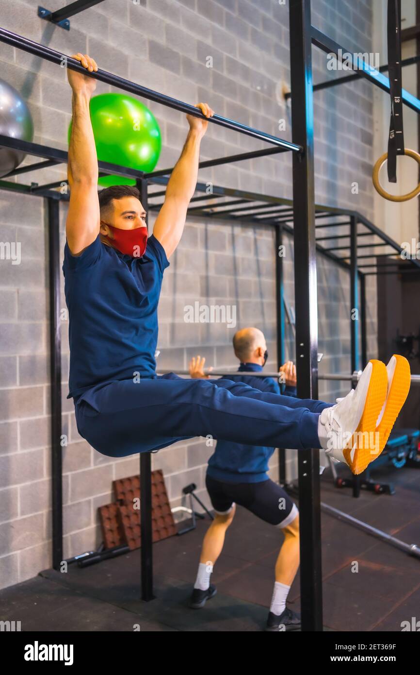 A view of Two athletes performing strength exercises in the gym during ...
