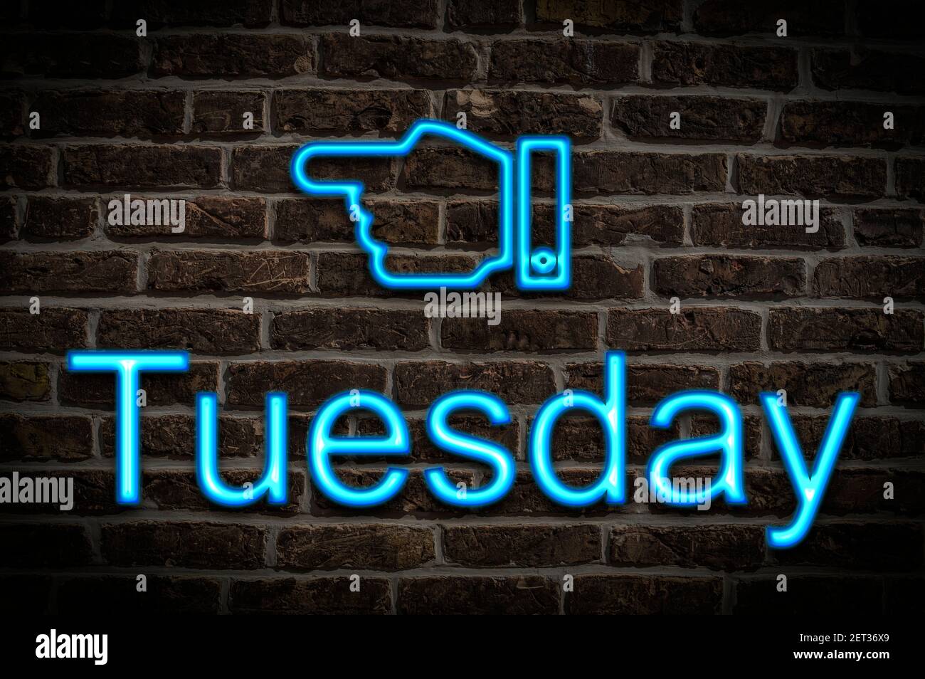 Detail photo of a neon sign on a wall with the inscription Tuesday ...