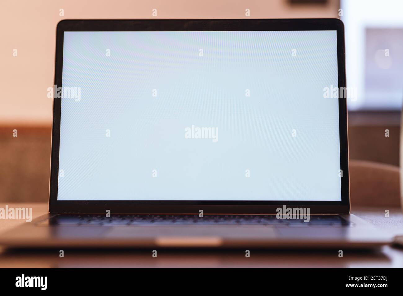 Conceptual workspace, Laptop computer with blank white screen on table ...