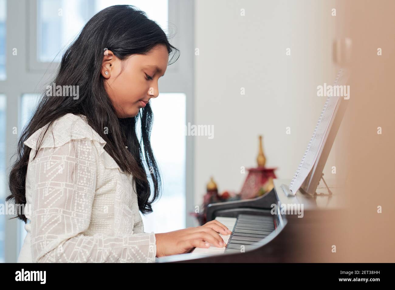 Teenage girl playing piano Stock Photo - Alamy