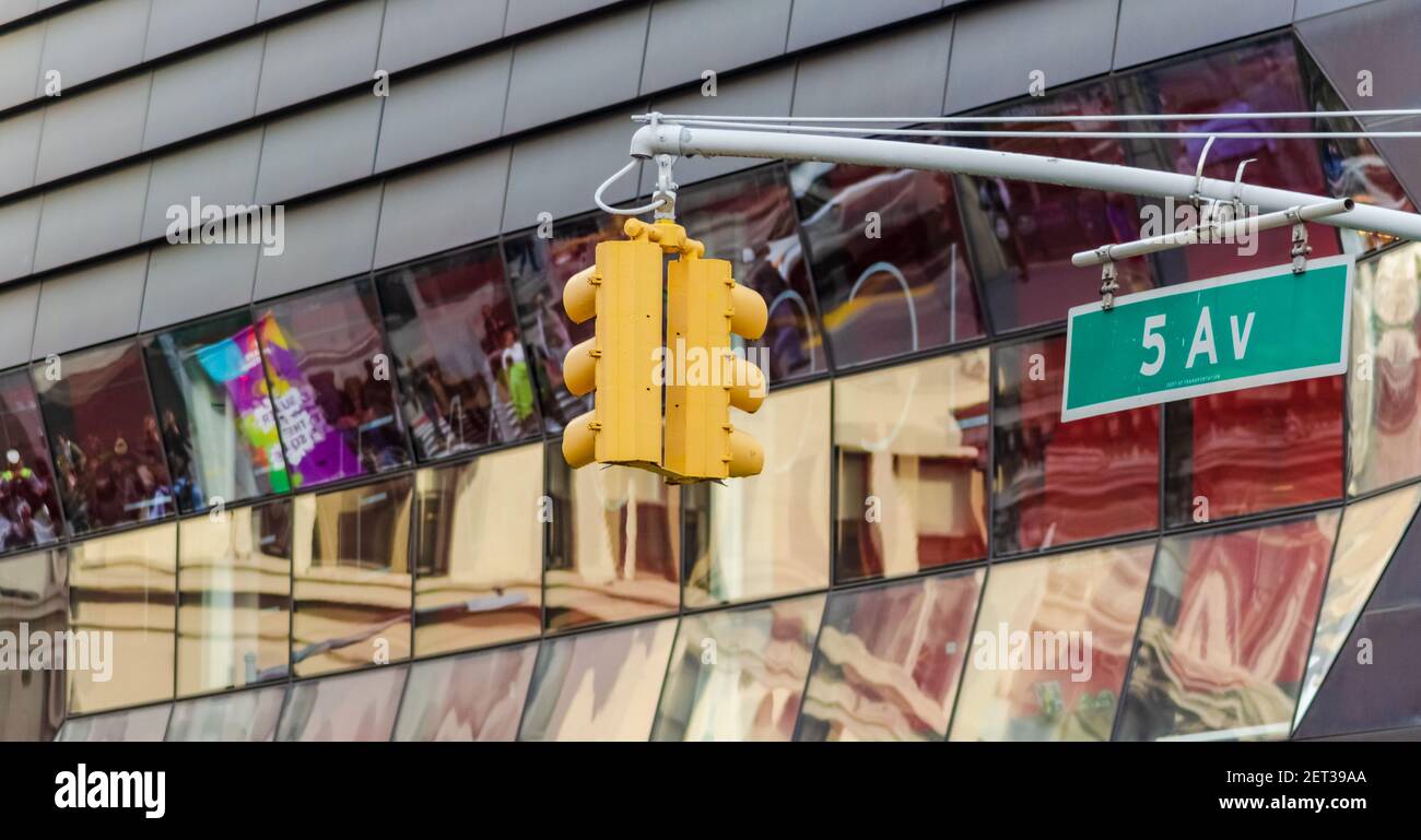 View of the red lights with the fifth avenue street sign and a building ...