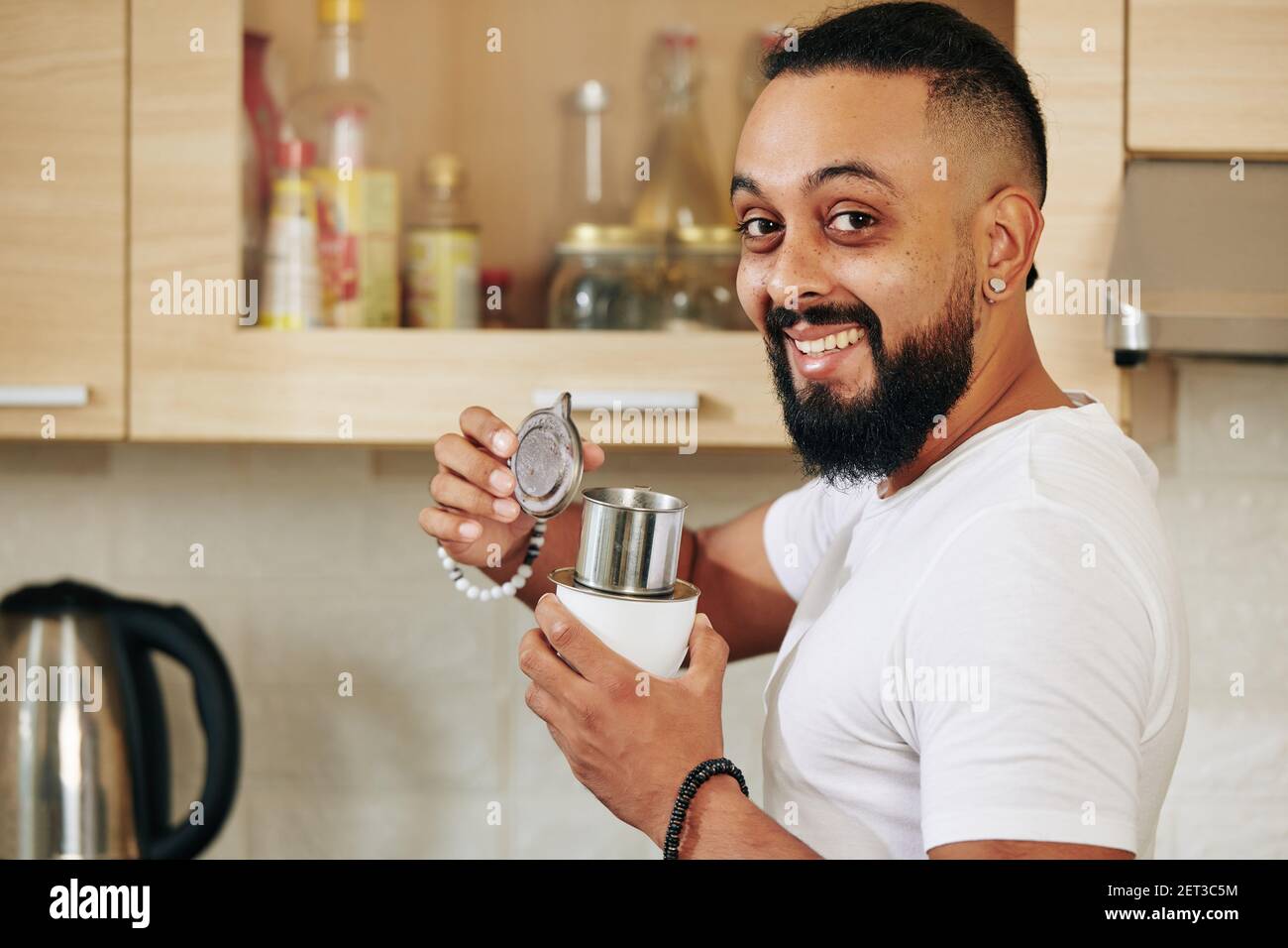 Man with coffee dripper Stock Photo - Alamy