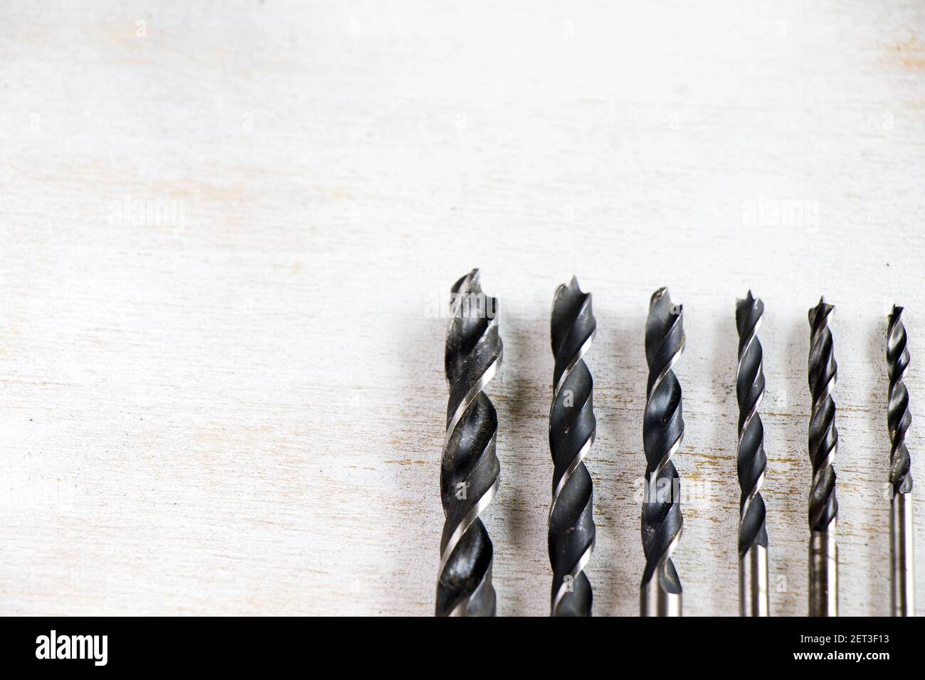 A top view of stainless cordless drill heads on a white background ...