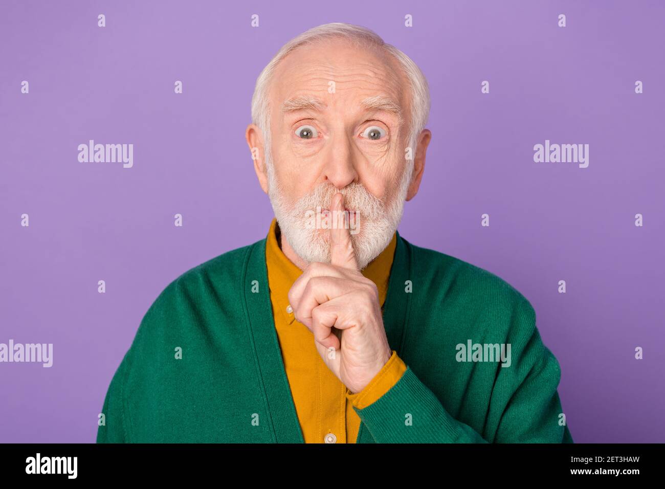 Portrait of serious aged person finger covering mouth look camera ...