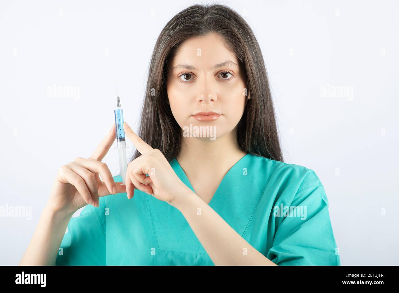 Portrait of female doctor holding a large syringe Stock Photo - Alamy