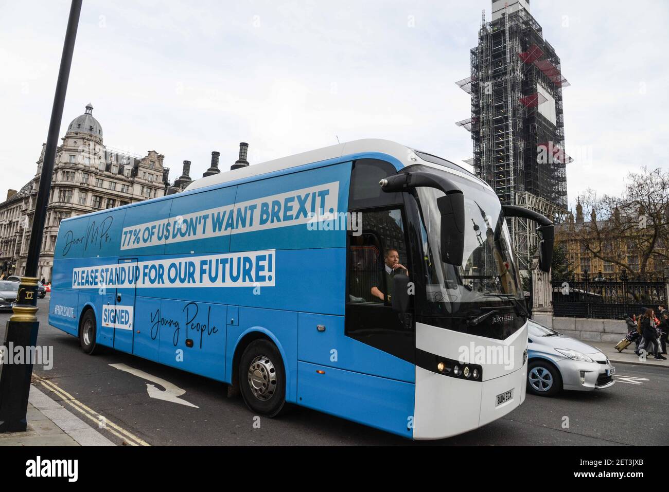 A bus with anti brexit slogans across it drives past the Houses of ...