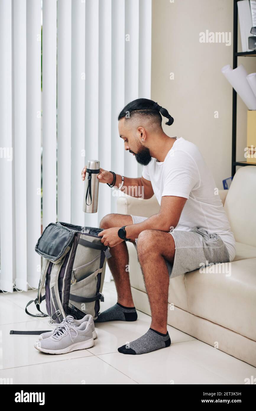 Young man packing Stock Photo - Alamy