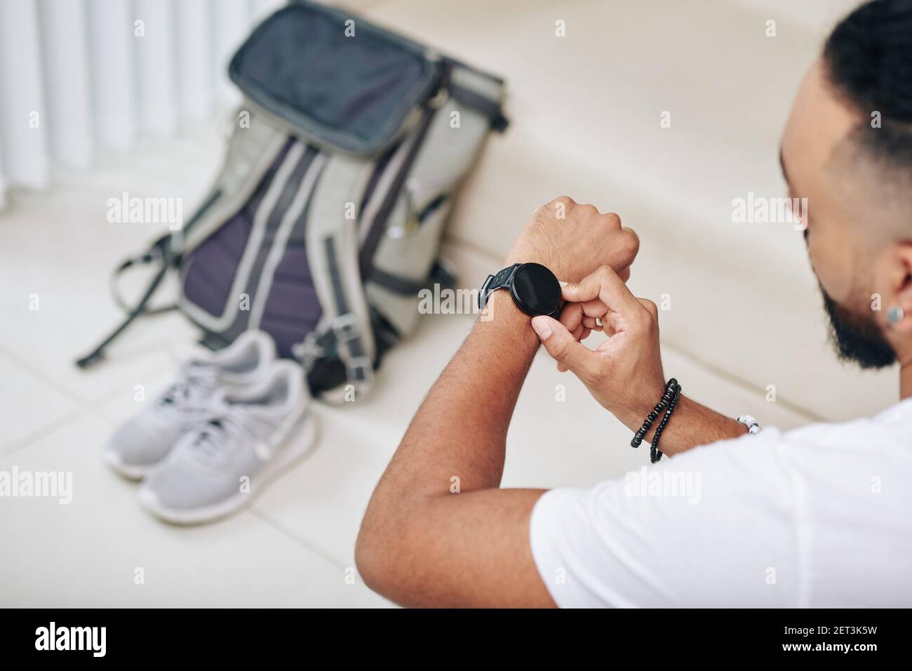 Man checking smartwatch Stock Photo - Alamy