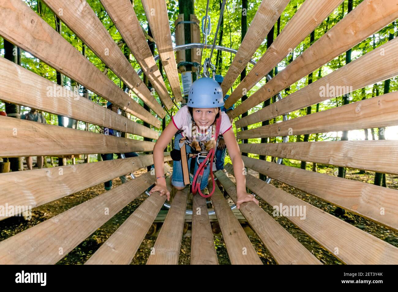 Young girl on the way in a climbing park in forest Stock Photo - Alamy