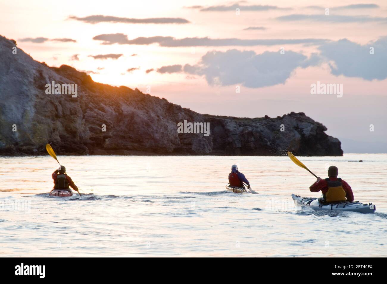 Sea Kayaking in the early morning around the aeolian islands in italy ...